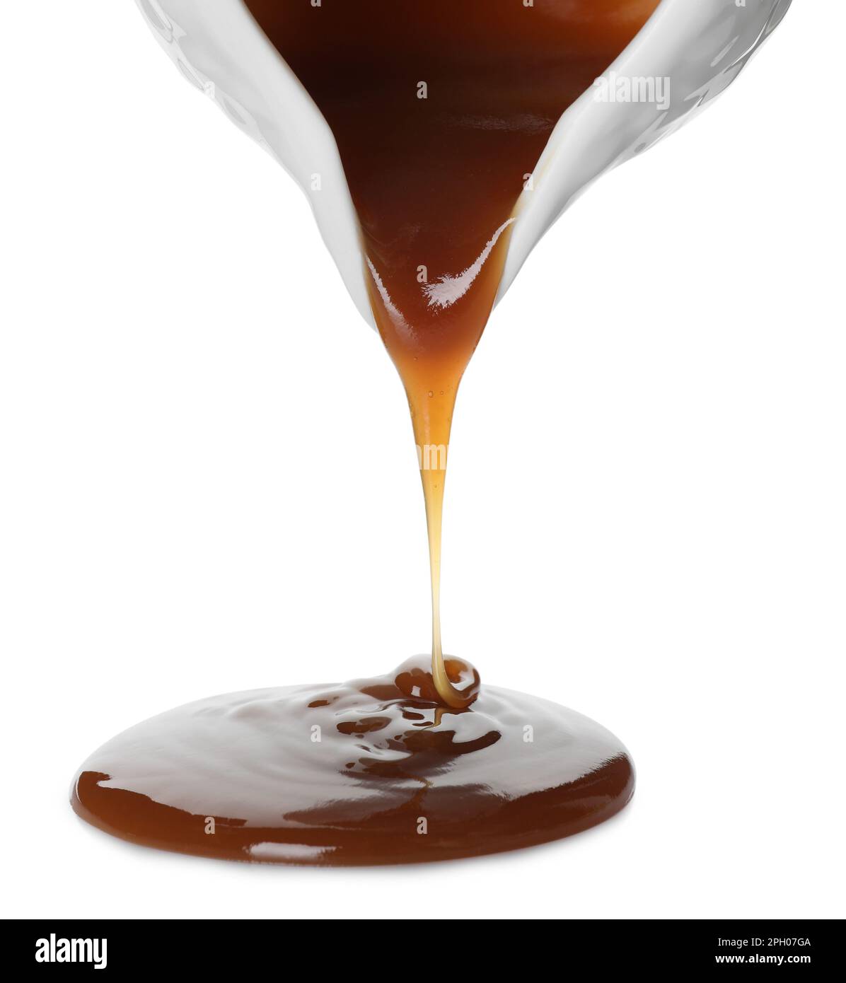Pouring sweet boiled condensed milk on white background Stock Photo - Alamy