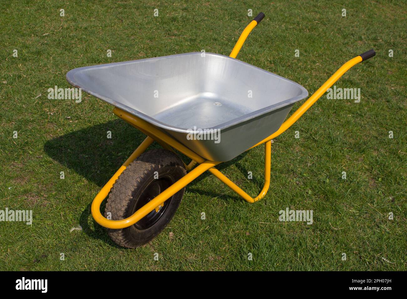 Gardening season green lawn with wheelbarrow new Stock Photo - Alamy