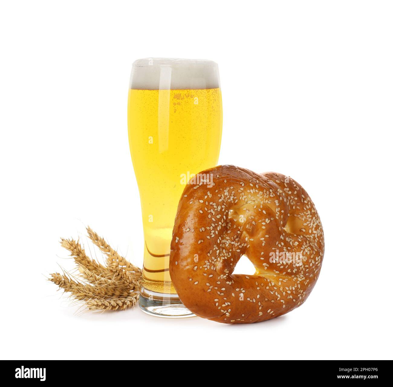 Tasty freshly baked pretzel, glass of beer and spikelets on white ...
