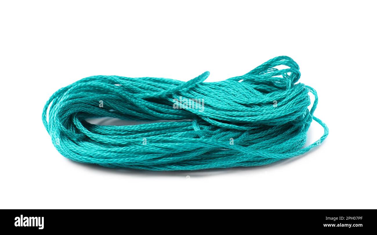 Bright turquoise embroidery thread on white background Stock Photo - Alamy