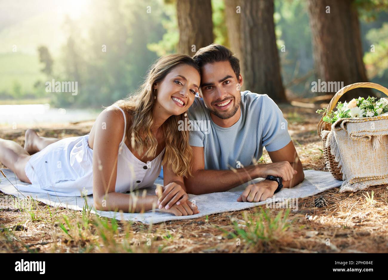 Couple on picnic, portrait and relax together in nature park, happy ...