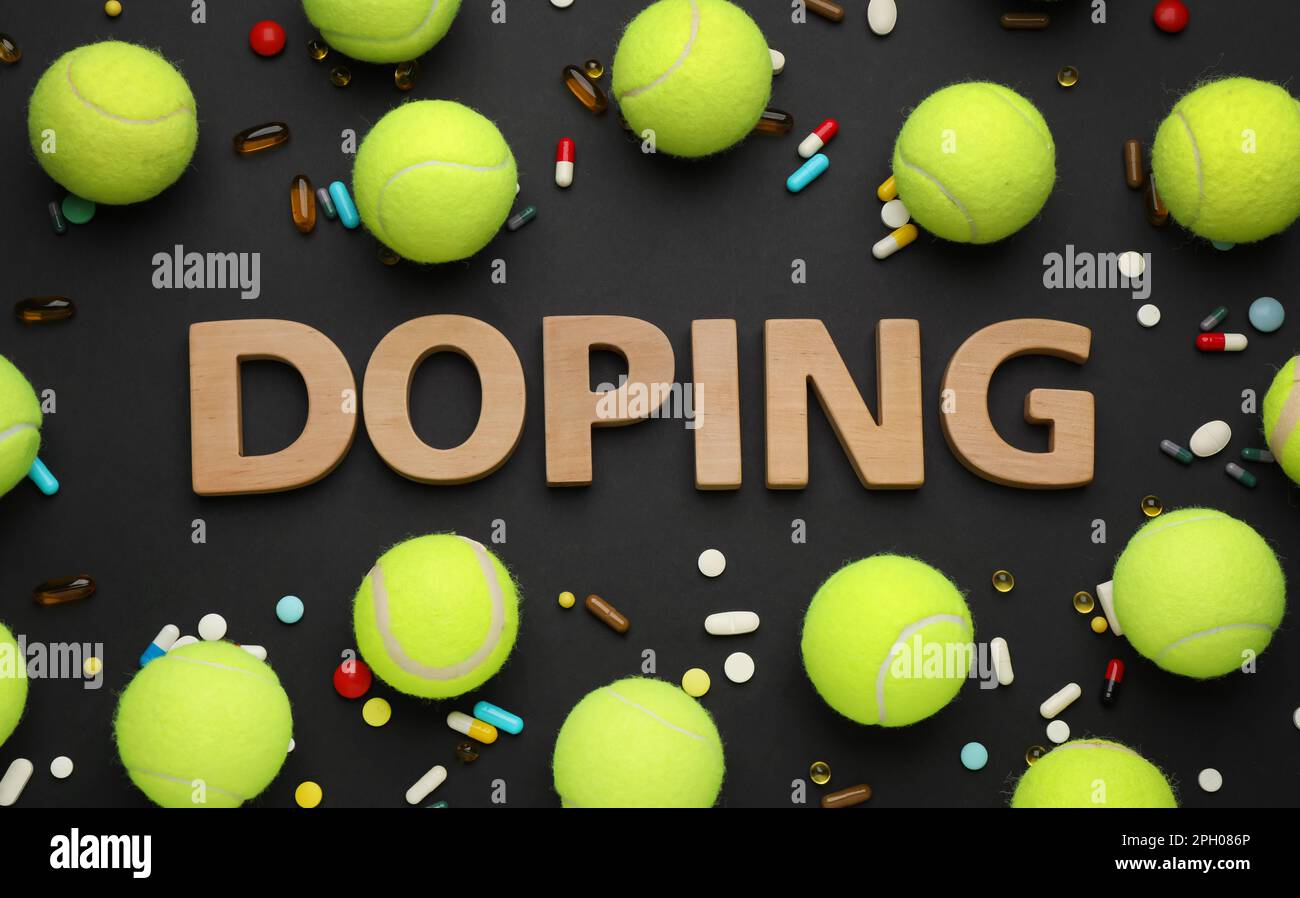 Flat lay composition with word Doping, tennis balls and drugs on black ...