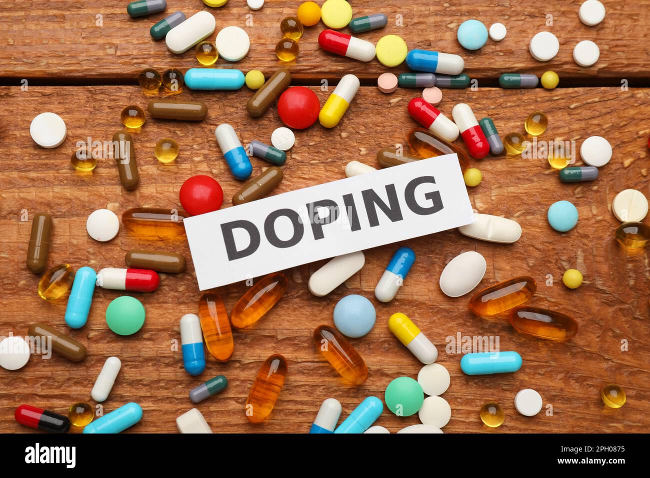Flat lay composition with word Doping and drugs on wooden table Stock ...
