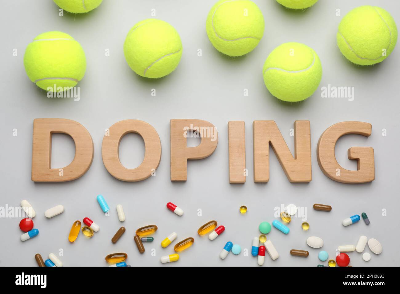 Flat lay composition with word Doping, tennis balls and drugs on light ...
