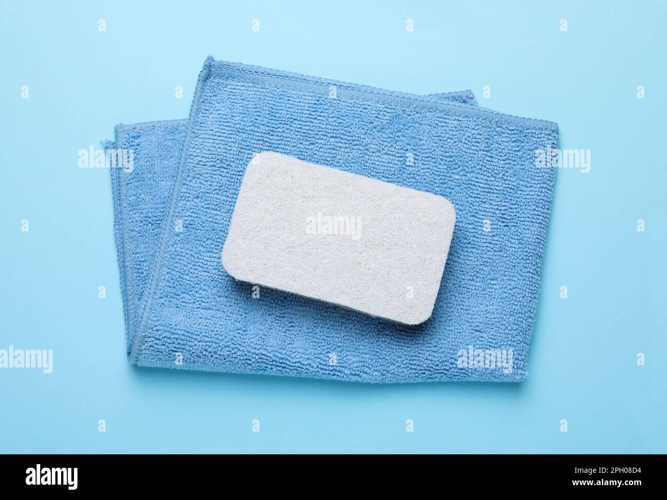 Sponge and rag on light blue background, top view Stock Photo - Alamy