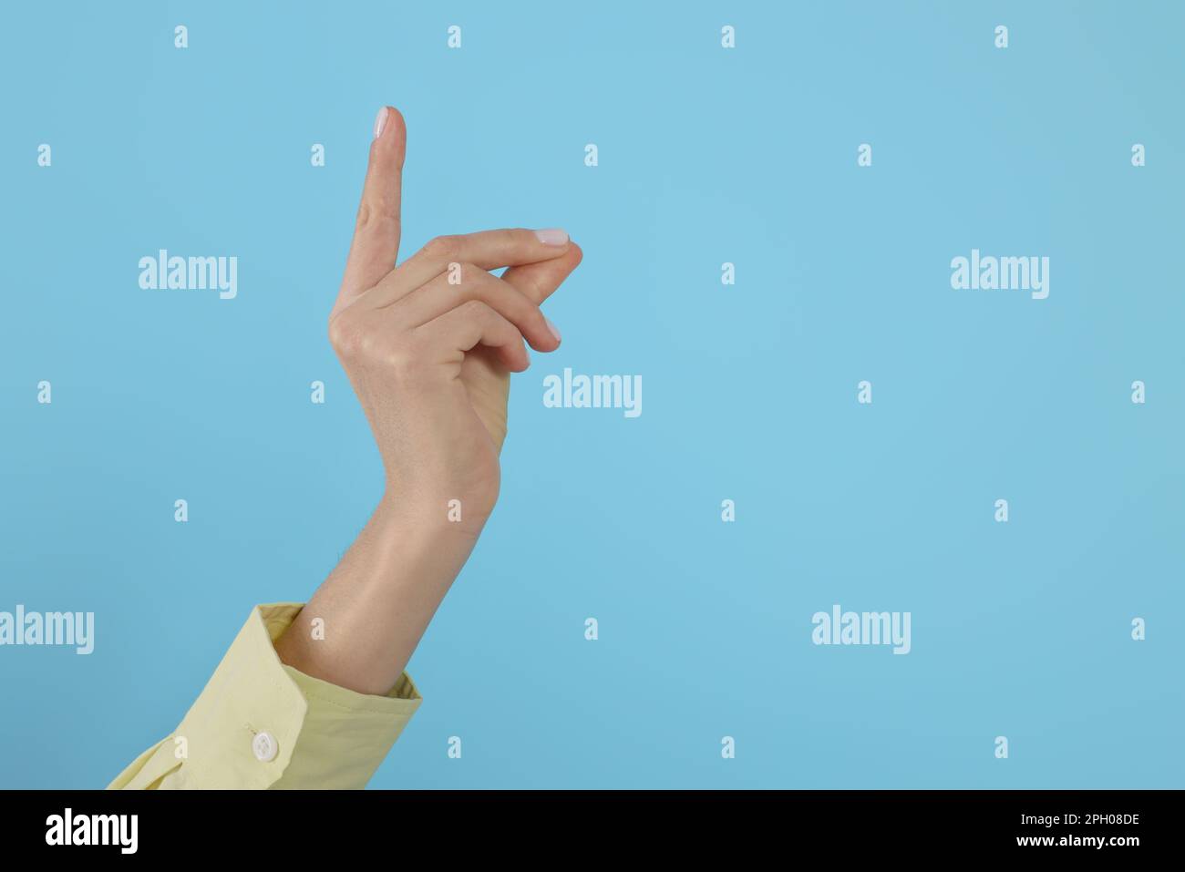 Woman snapping fingers on light blue background, closeup of hand. Space ...