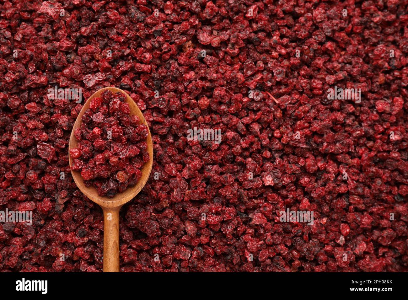 Wooden spoon on dried red currants, top view. Space for text Stock ...