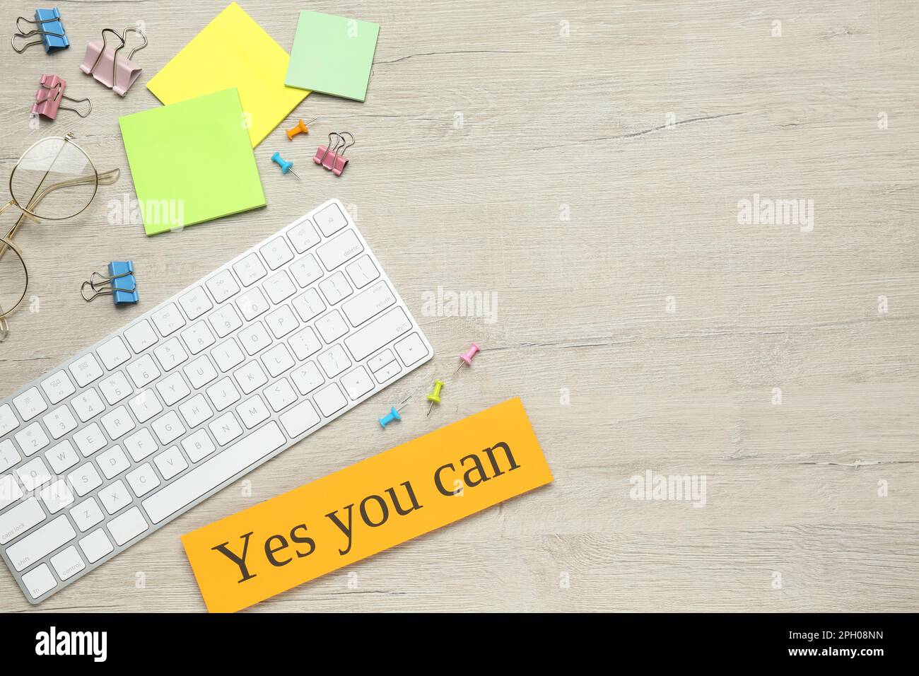 Note with motivational quote Yes you can, computer keyboard and office ...
