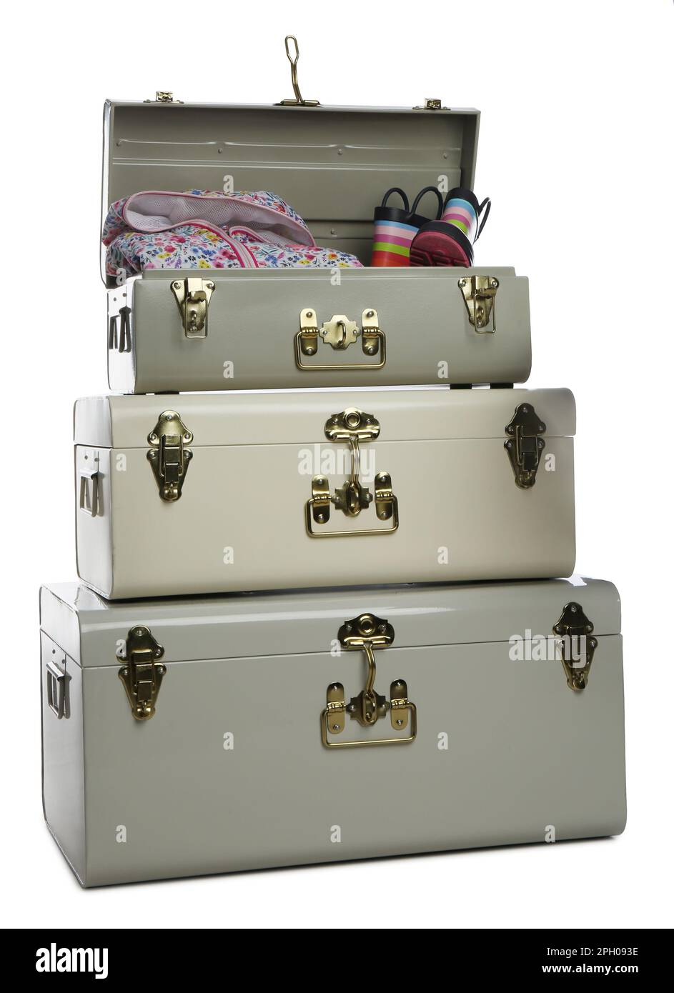 Stylish storage trunks with clothes and boots on white background ...