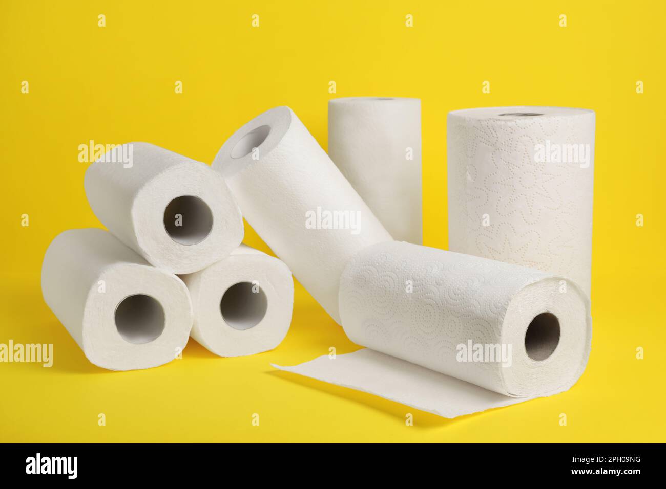 Many rolls of paper towels on yellow background Stock Photo - Alamy