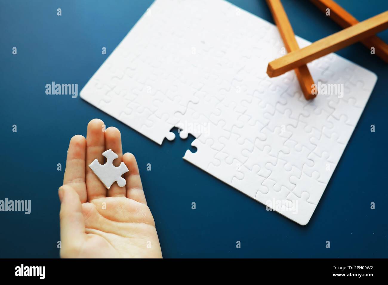 Intellectual puzzles. The puzzle empty. The hand puts together puzzle ...