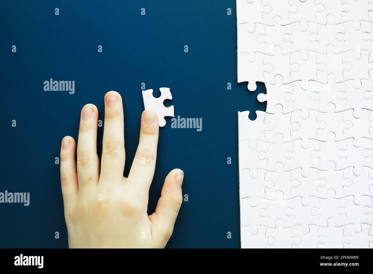 Intellectual puzzles. The puzzle empty. The hand puts together puzzle ...