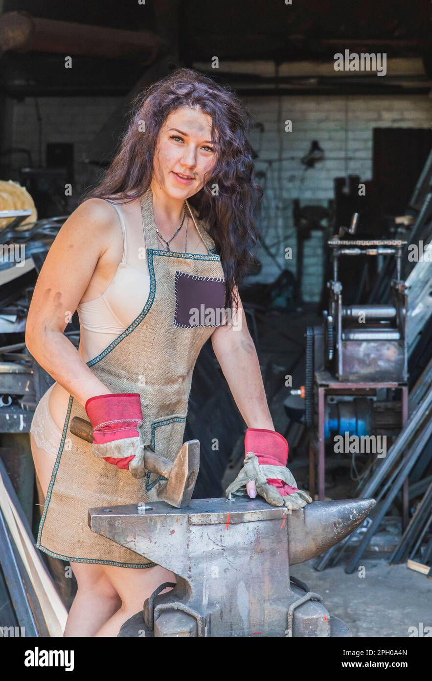 the blacksmith stands in the workshop near the anvil Stock Photo - Alamy