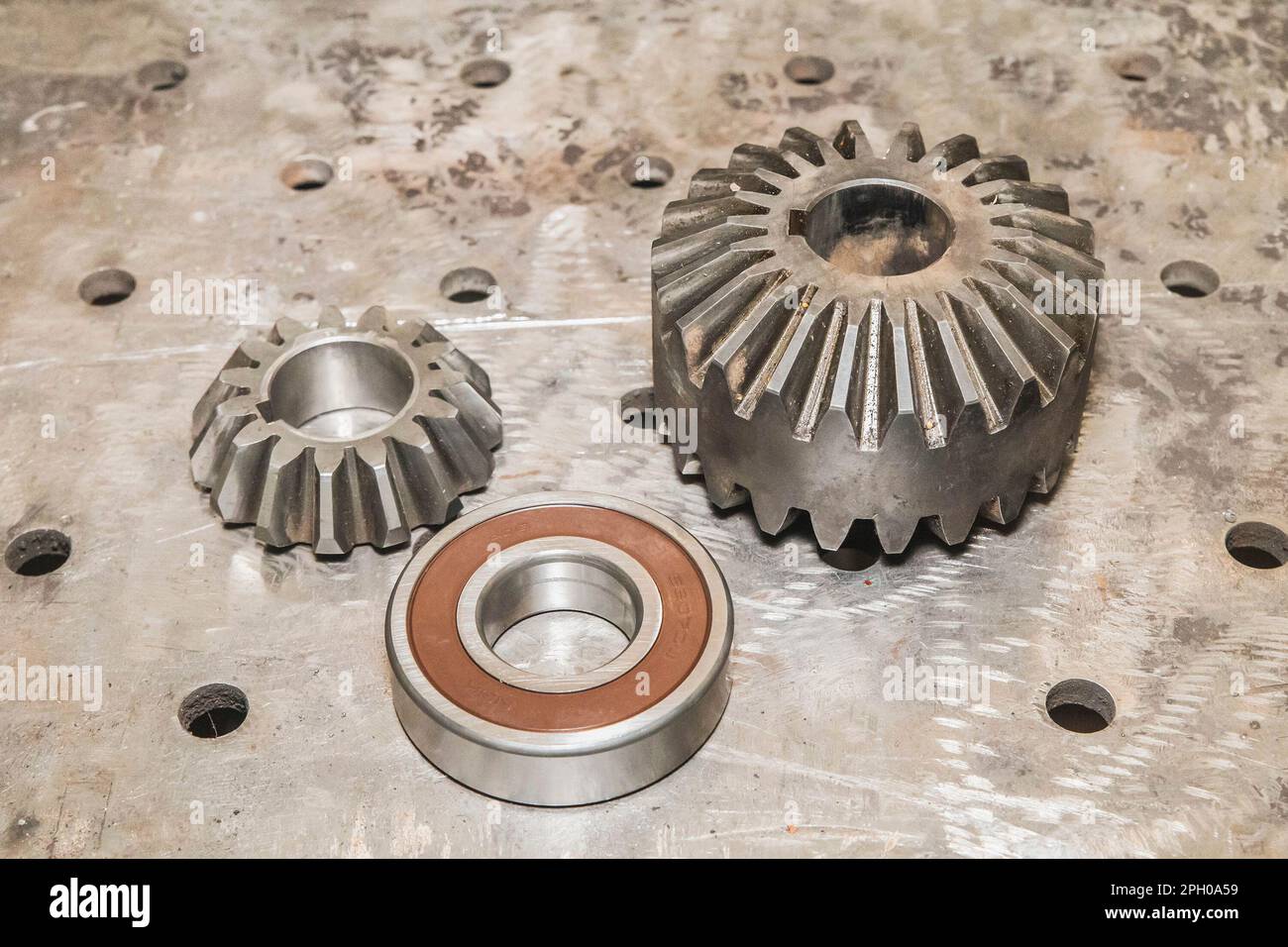 gears and bearing lie on a metal tabletop at the factory Stock Photo ...