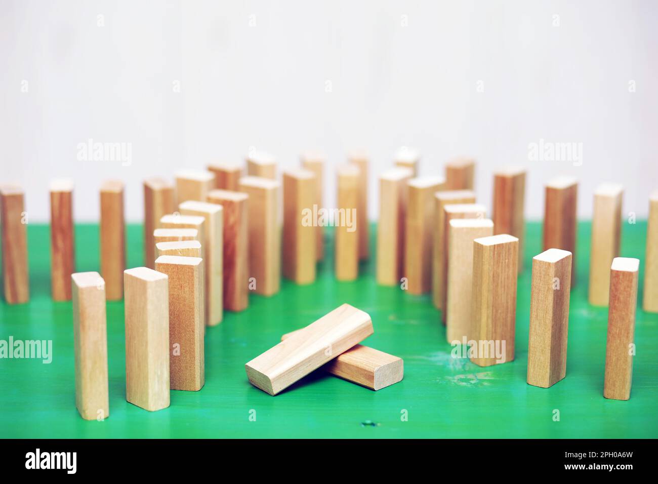 Stick wood block standing on stacked square wood blocks, abstract ...