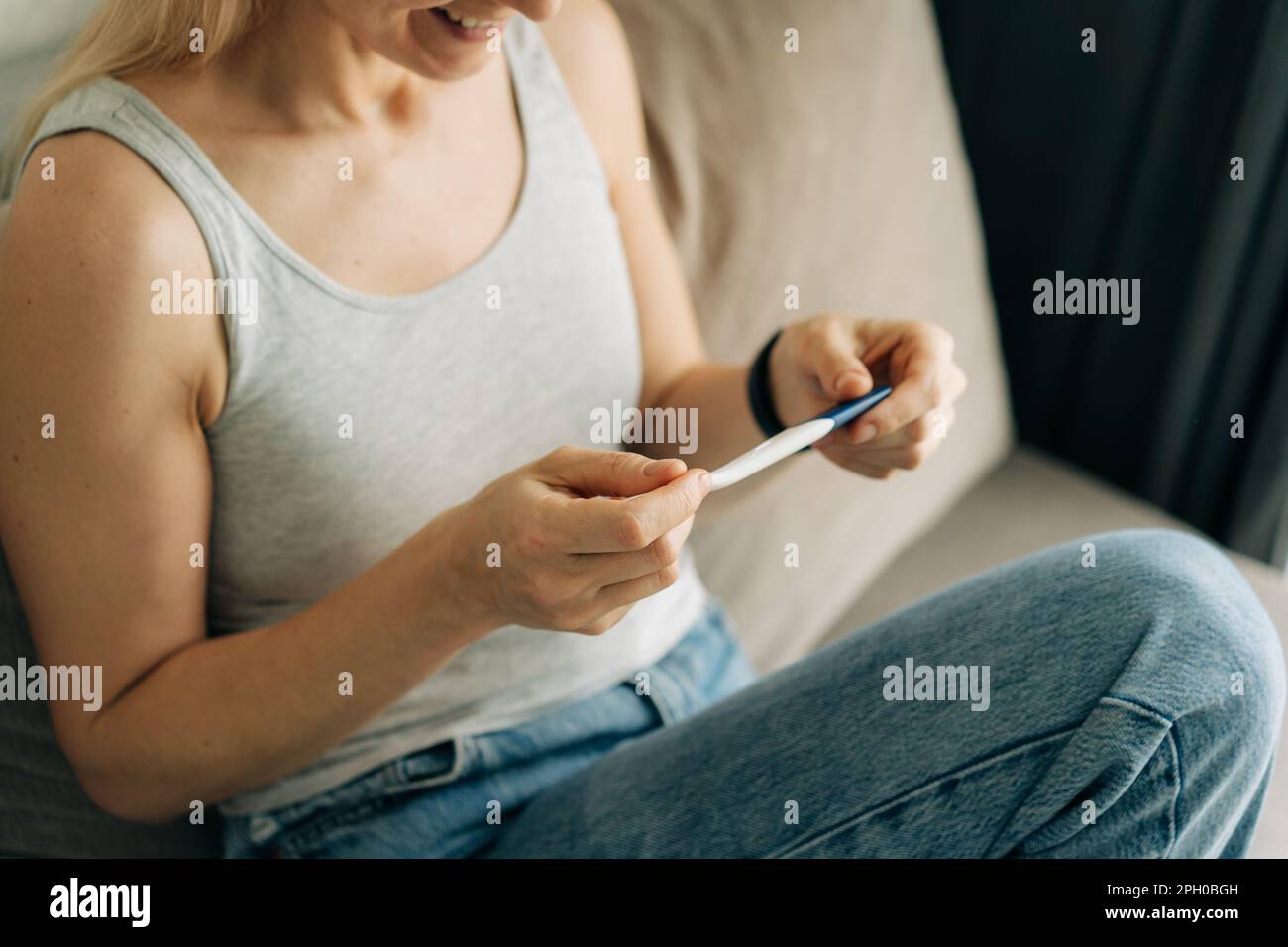 Unrecognizable woman checking pregnancy test, waiting for test result ...