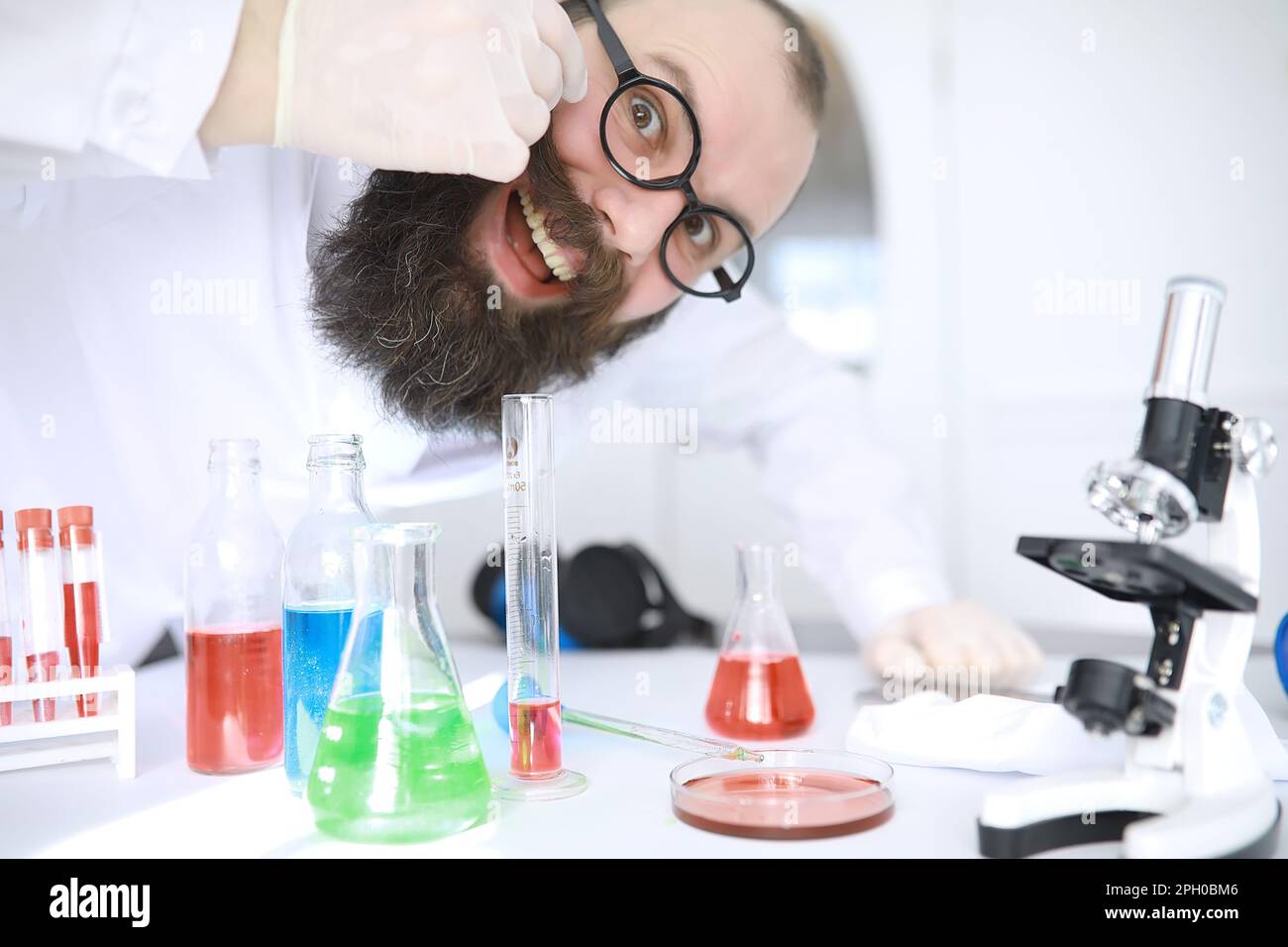 Chemist crazy. A mad scientist conducts experiments in scientific ...