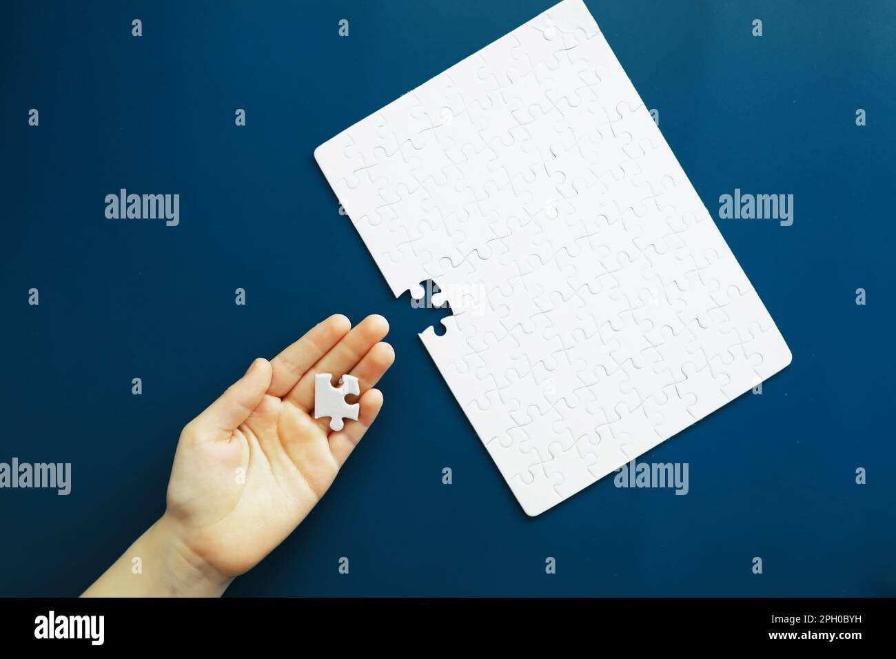 Intellectual puzzles. The puzzle empty. The hand puts together puzzle ...
