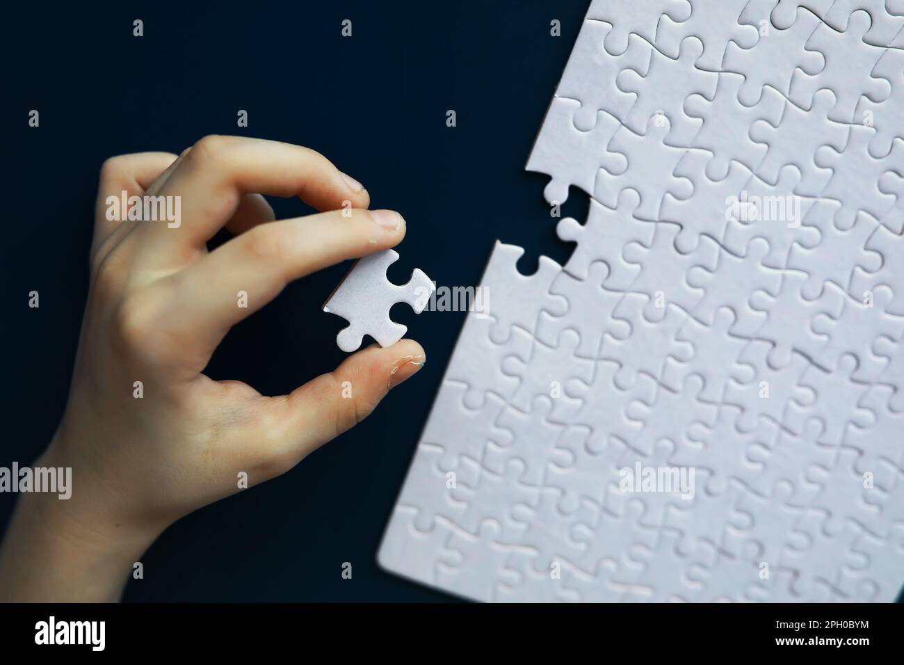 Intellectual puzzles. The puzzle empty. The hand puts together puzzle ...