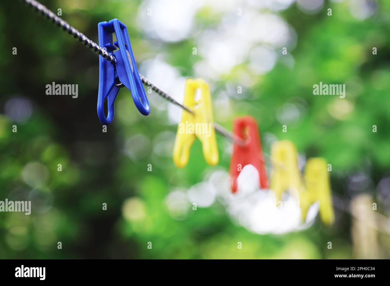 Clothespins on a clothesline in summer. Dry clothes outside. Clothes on ...