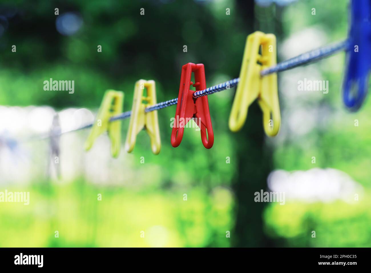 Clothespins on a clothesline in summer. Dry clothes outside. Clothes on ...