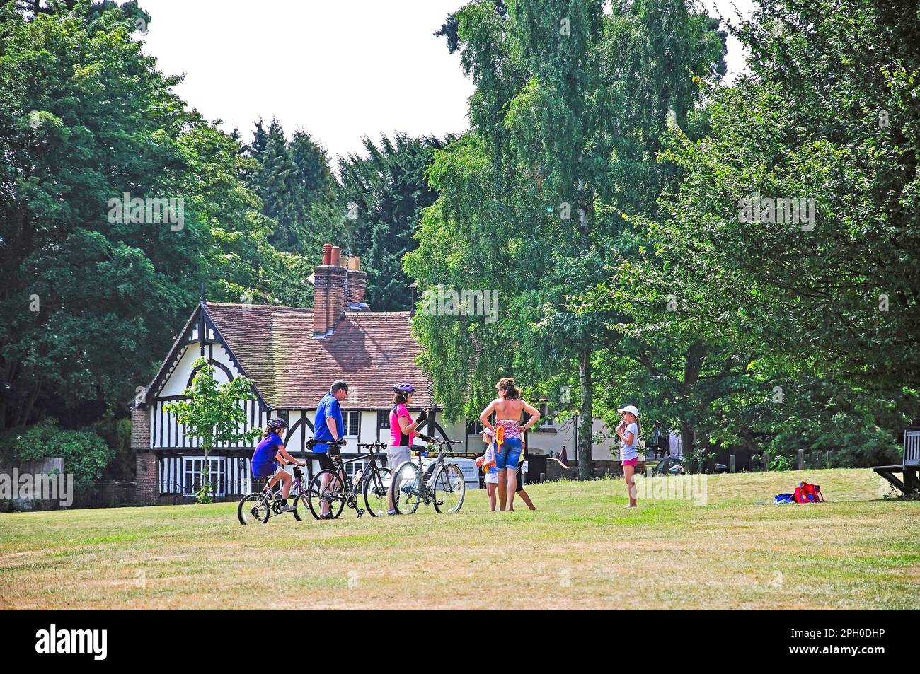 Family with bicycles on The Green, Bearsted, Maidstone District, Kent ...