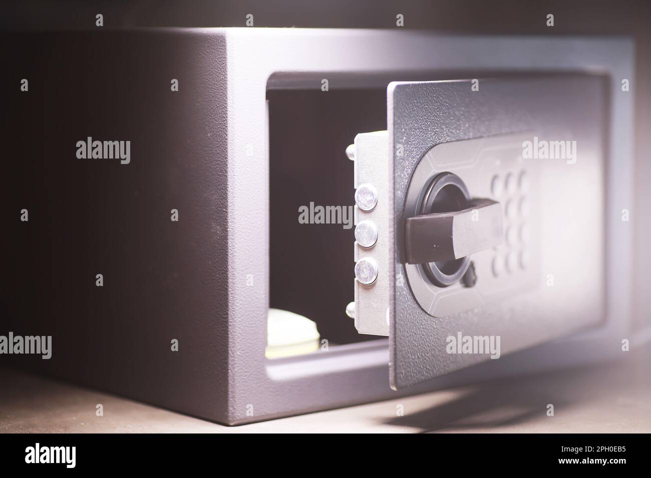 Steel safe with money. Hand putting password in the safety money box in ...