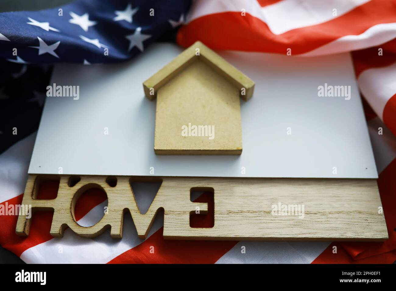 House symbol on American flag. Mortgage credit lending. Housing safety ...