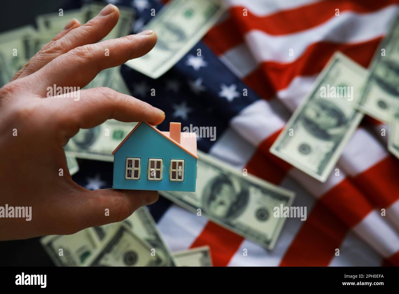 House symbol on American flag. Mortgage credit lending. Housing safety ...