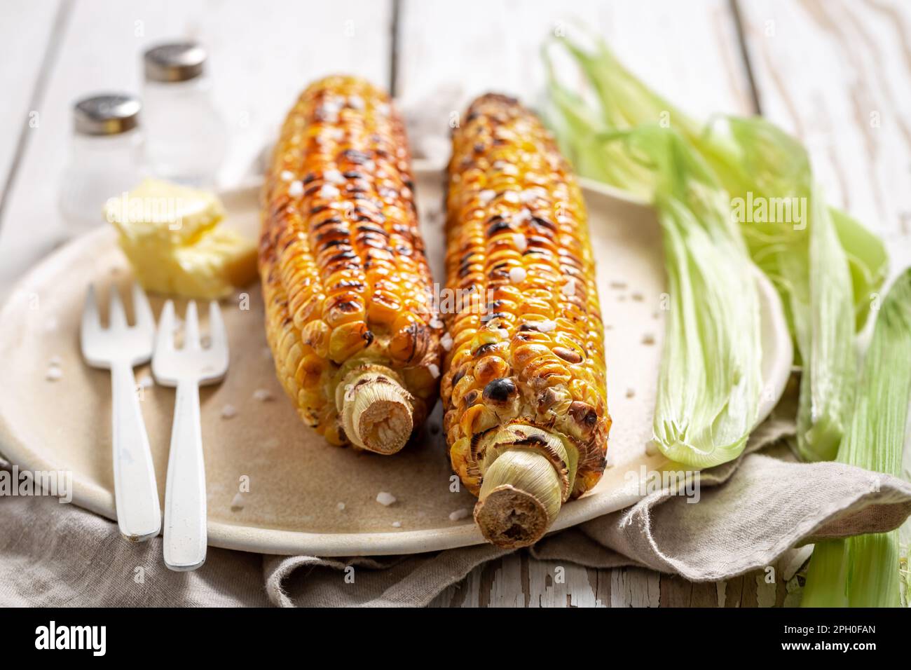 Sweet and salty grilled corn cob with melting butter and salt. Roasted ...
