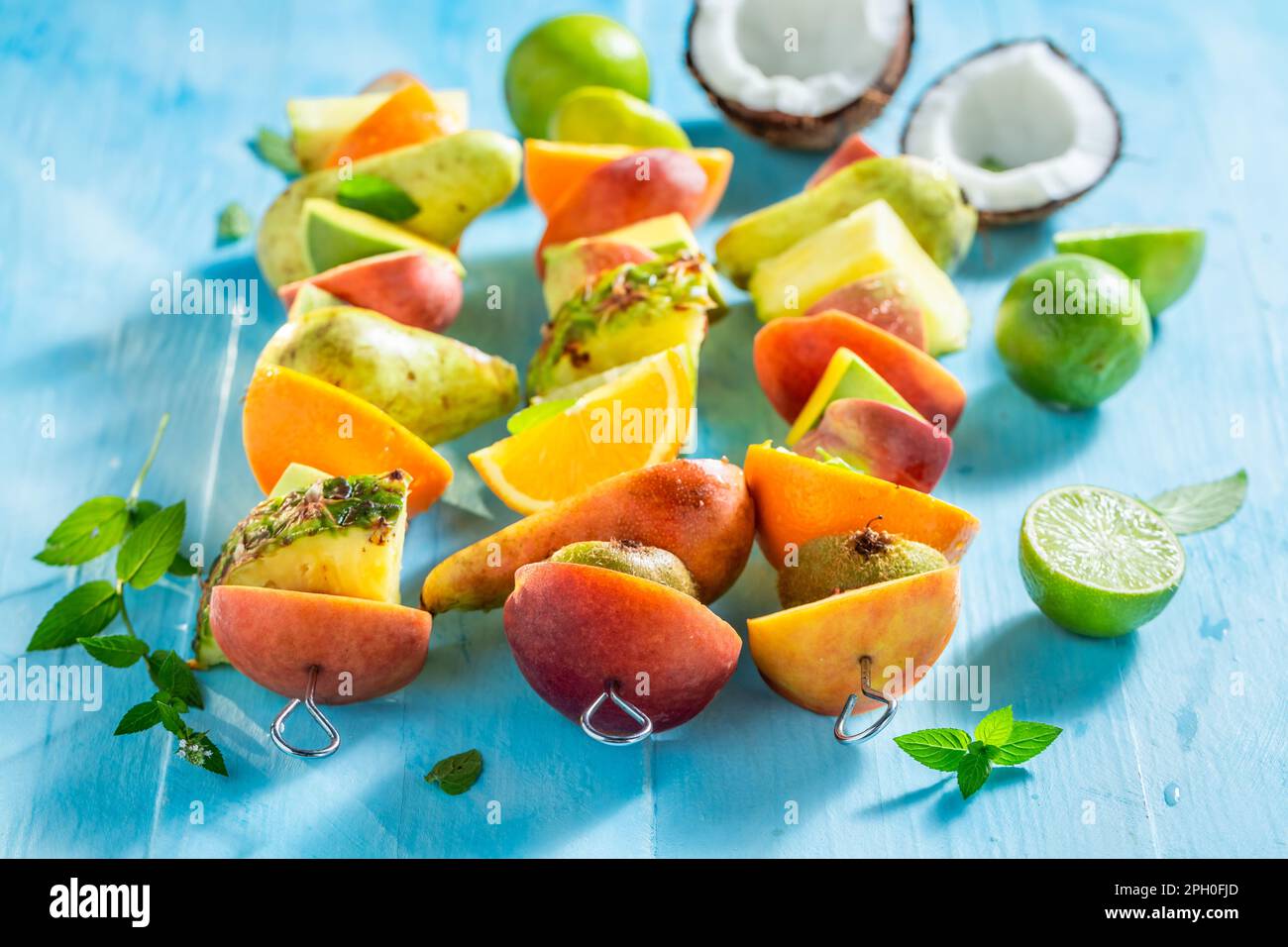 Tasty and sweet skewers with many exotic fruits for snack. Skewers of ...