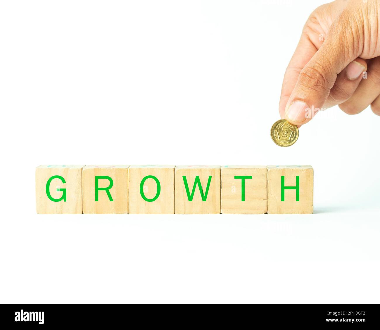 Word GROWTH written on toy blocks and coin in human hand on table with ...