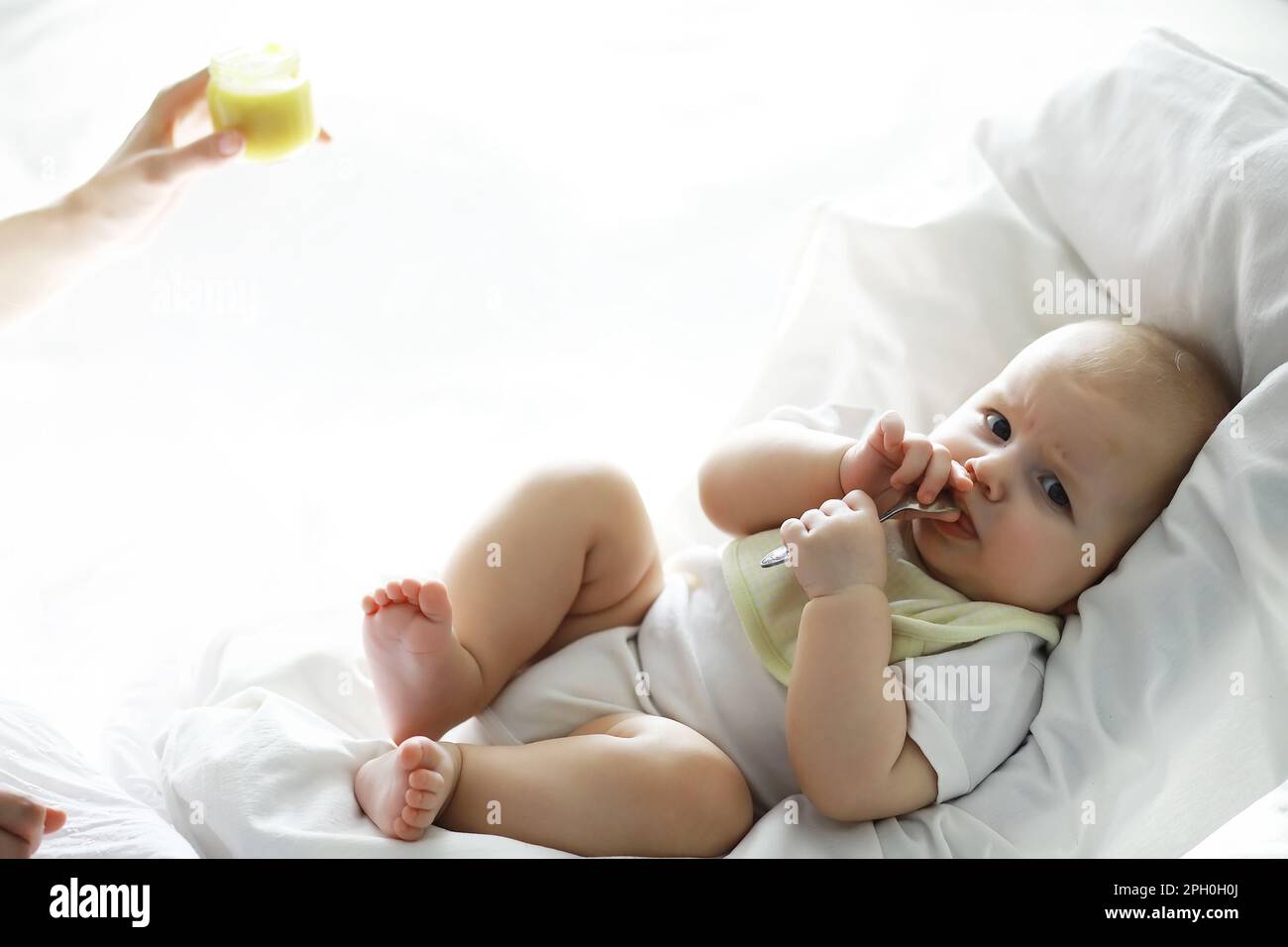 Maternity concept. A young mother feeds her little baby. First lure and ...