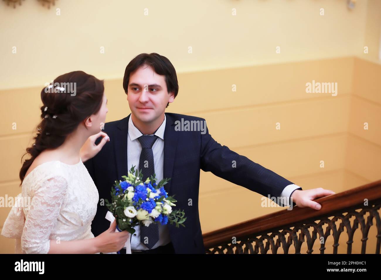 Portrait of emotional lovers of brides indoor.Bride and groom kisses ...