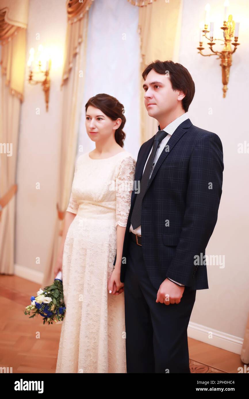 Portrait of emotional lovers of brides indoor.Bride and groom kisses ...