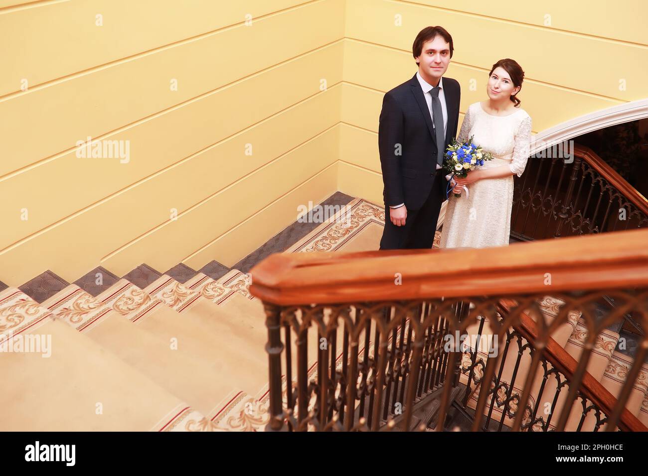 Portrait of emotional lovers of brides indoor.Bride and groom kisses ...