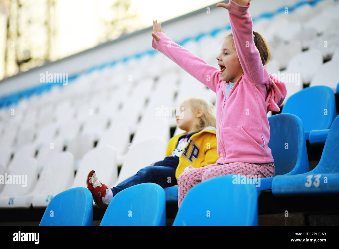 Plastic chairs in the stands of a sports stadium. Cheer on the stands ...