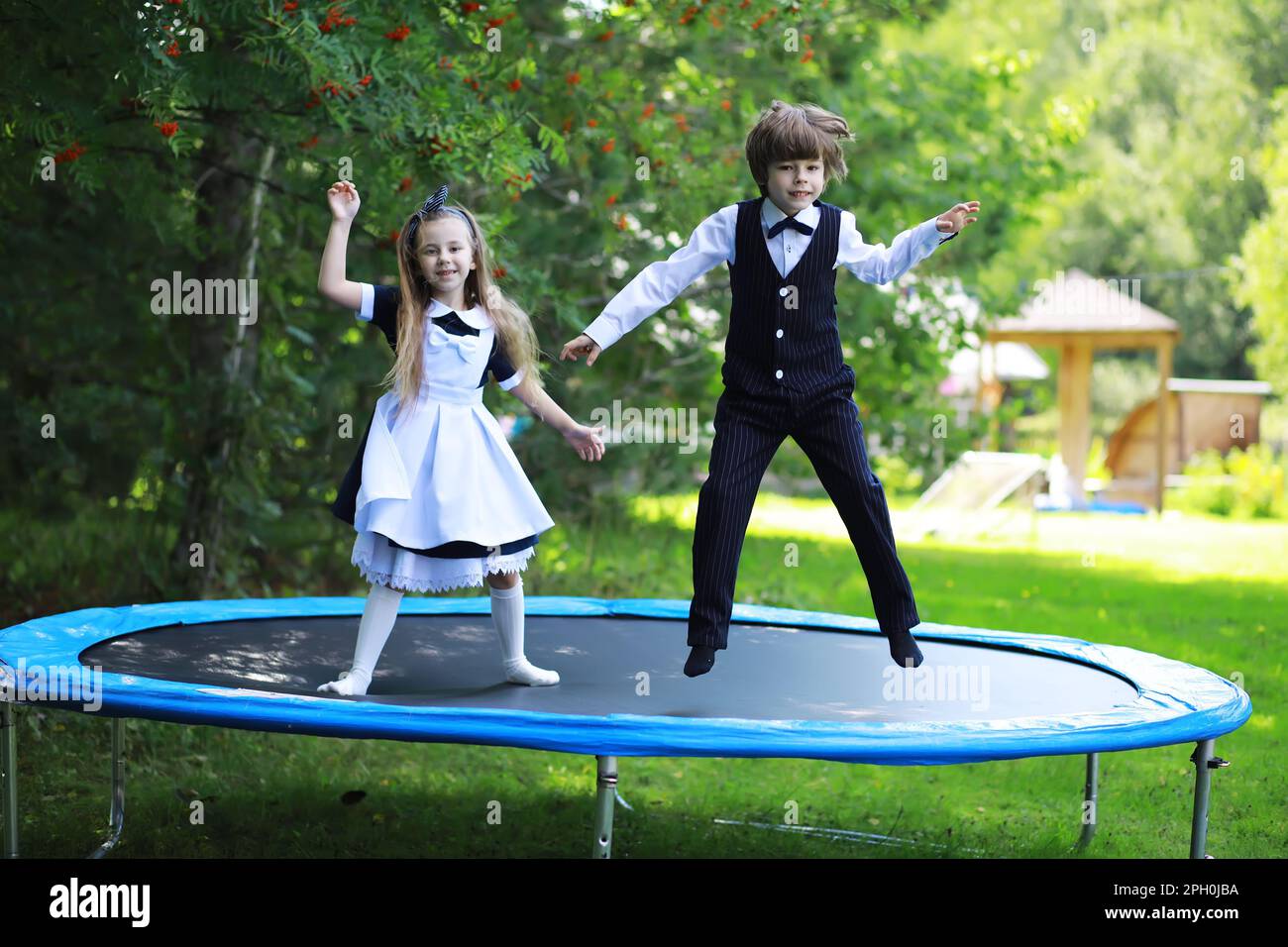 Children in school uniforms walk on the street. Children rejoice and ...