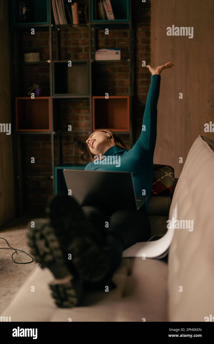 Excited girl waving her hands up and feeling relieved after she ...