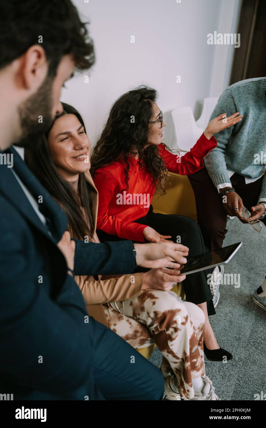 Curly haired girl asking her black male colleague for his opinion cause ...