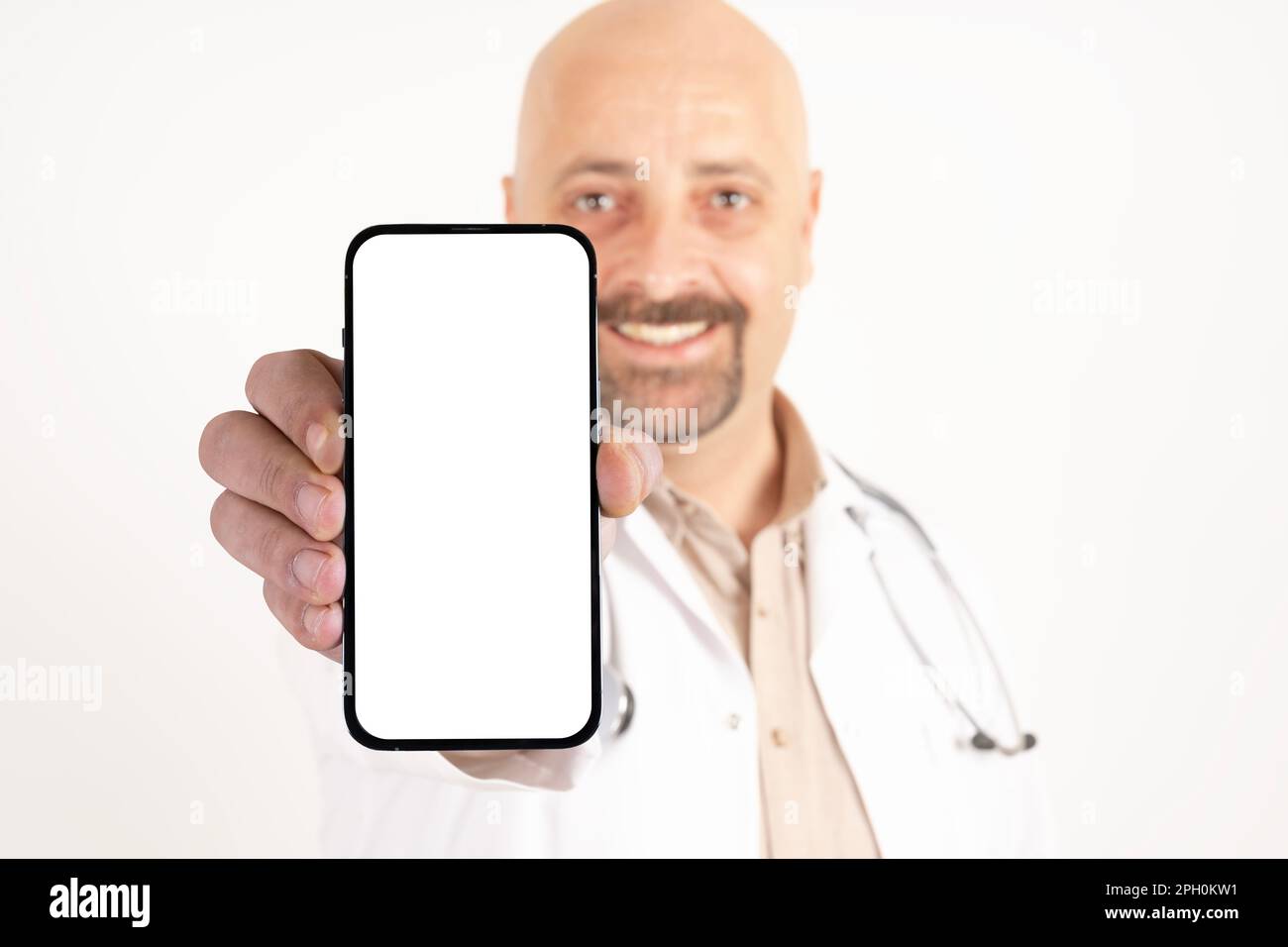 Caucasian male doctor showing smartphone. Big blank empty white screen ...