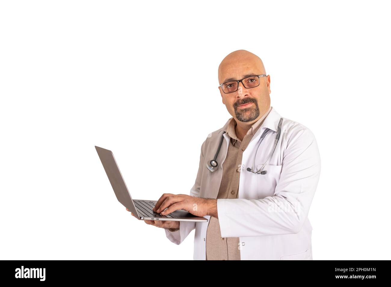 Portrait of bald middle aged handsome bearded doctor using laptop ...