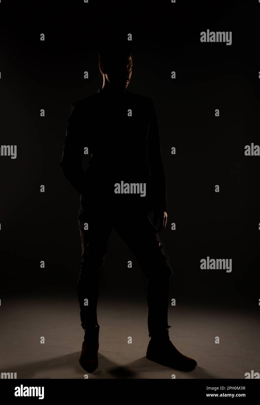 Attractive man posing in front of the camera with a slightly tilted ...
