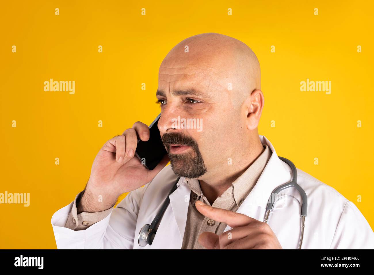 Medicine professional talking on phone. Doctor talking over his mobile ...