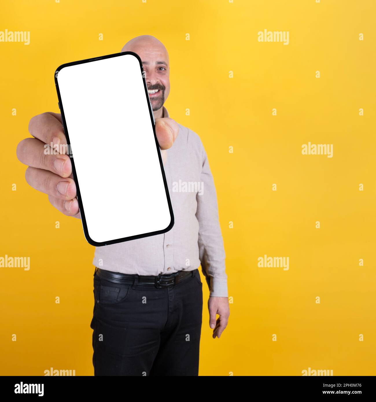 Excited happy caucasian bald man showing smartphone. Big mobile phone ...