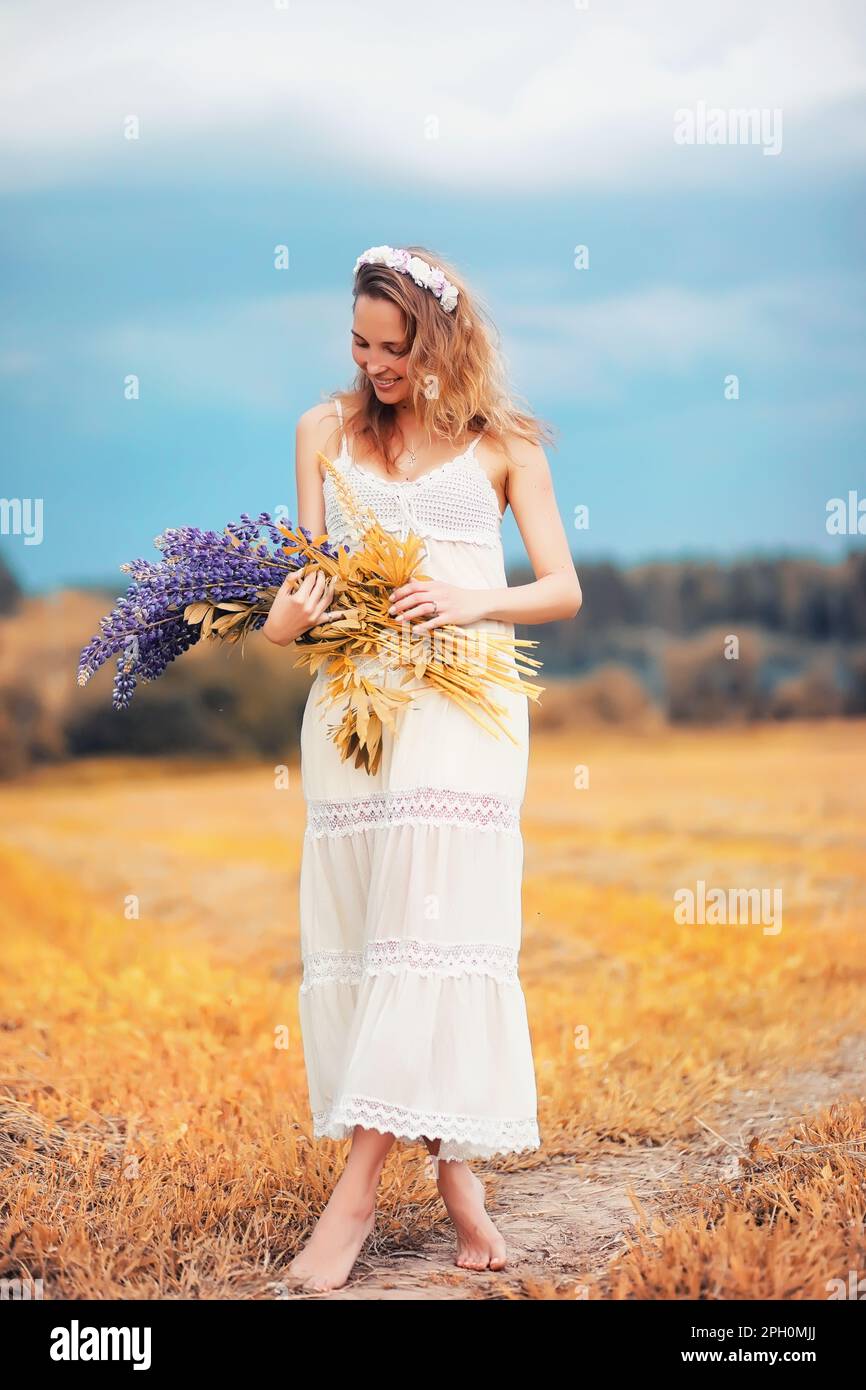 Beautiful girl with a bouquet of blue flowers on nature in autumn Stock ...