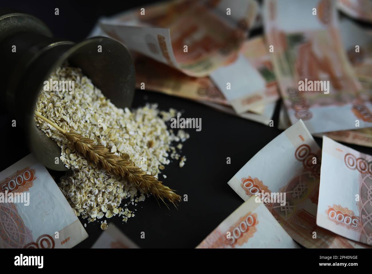 The concept of the cost of grain. 5000 ruble banknotes around a handful ...