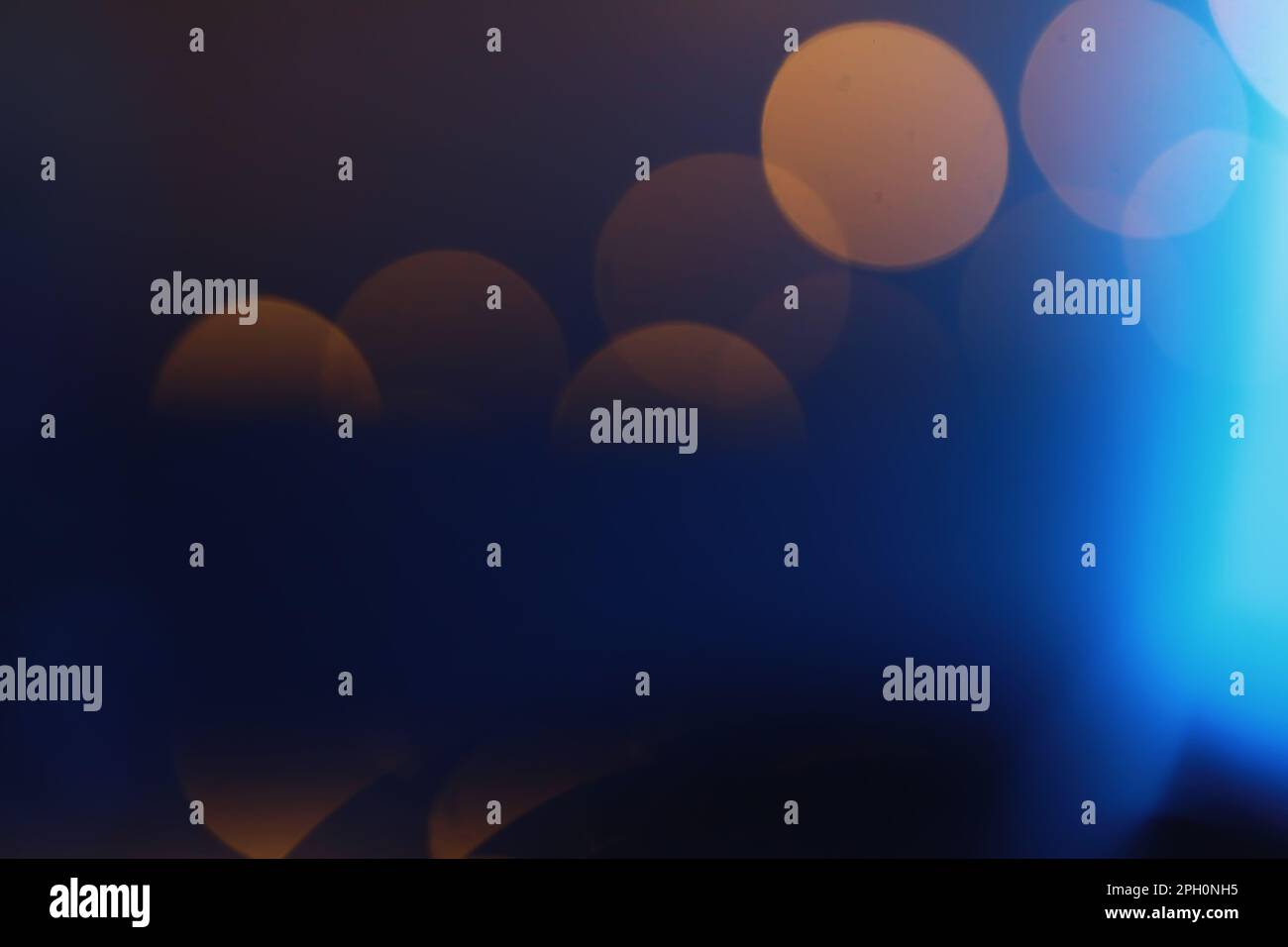 Abstract bokeh background. Golden bokeh circles on a dark blue ...