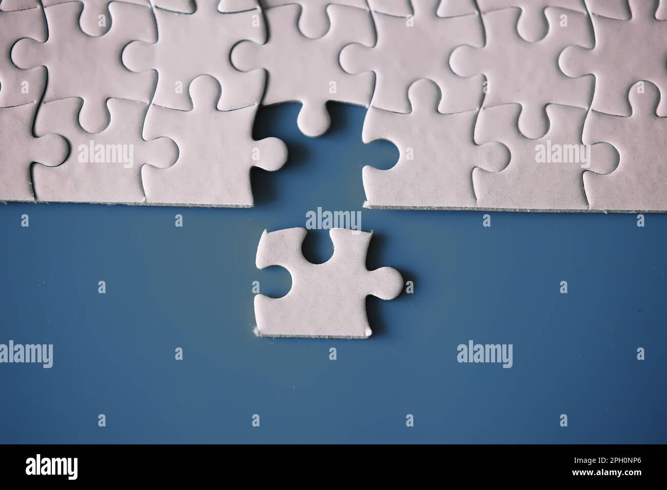 Clean puzzle elements on the background. Empty puzzle piece on table ...