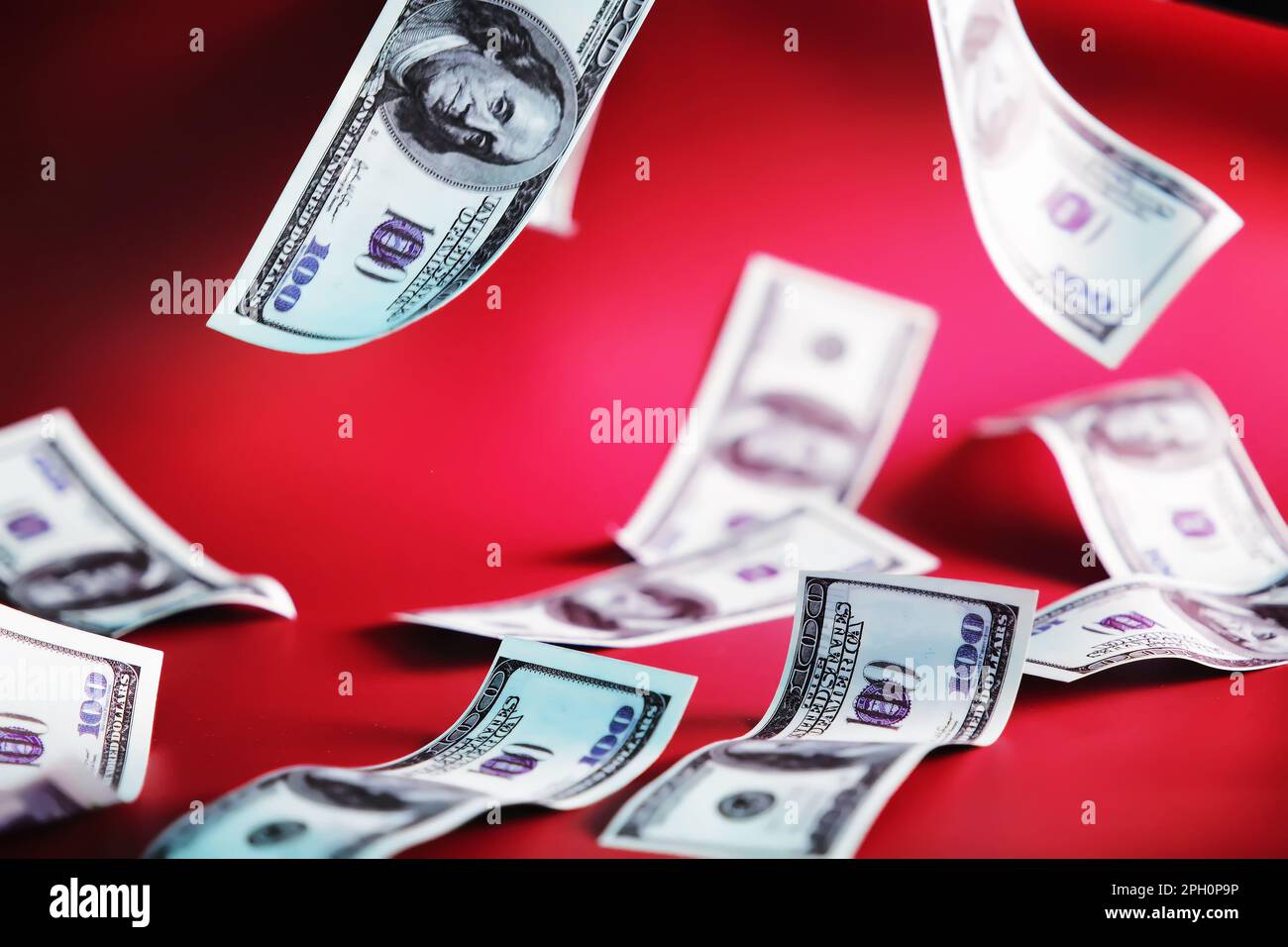 Green dollar bills on a blue background. 100 dollar bills close up. The ...